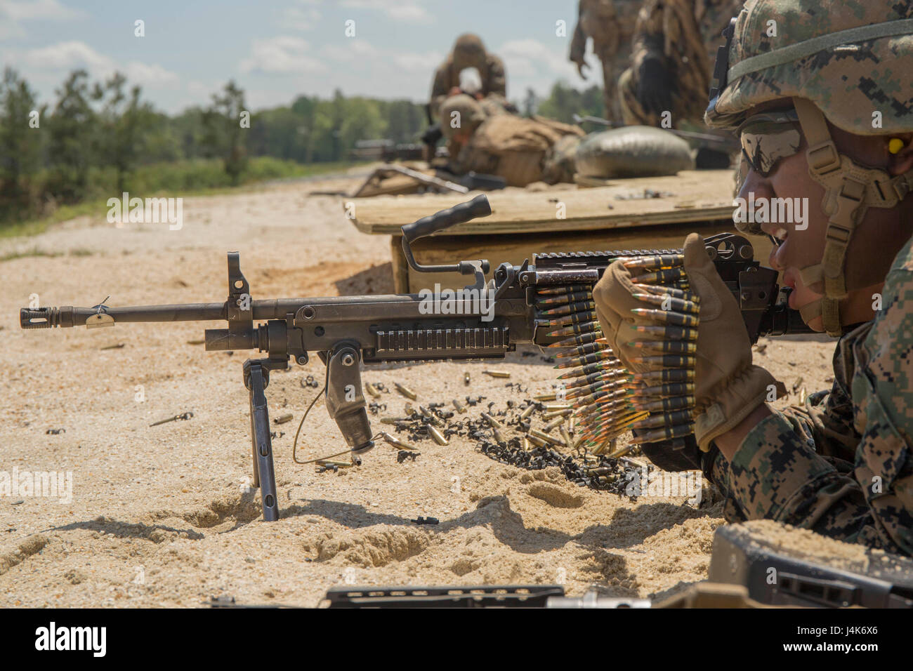A Marine fires an M249 light machine gun during a machine gun course at ...