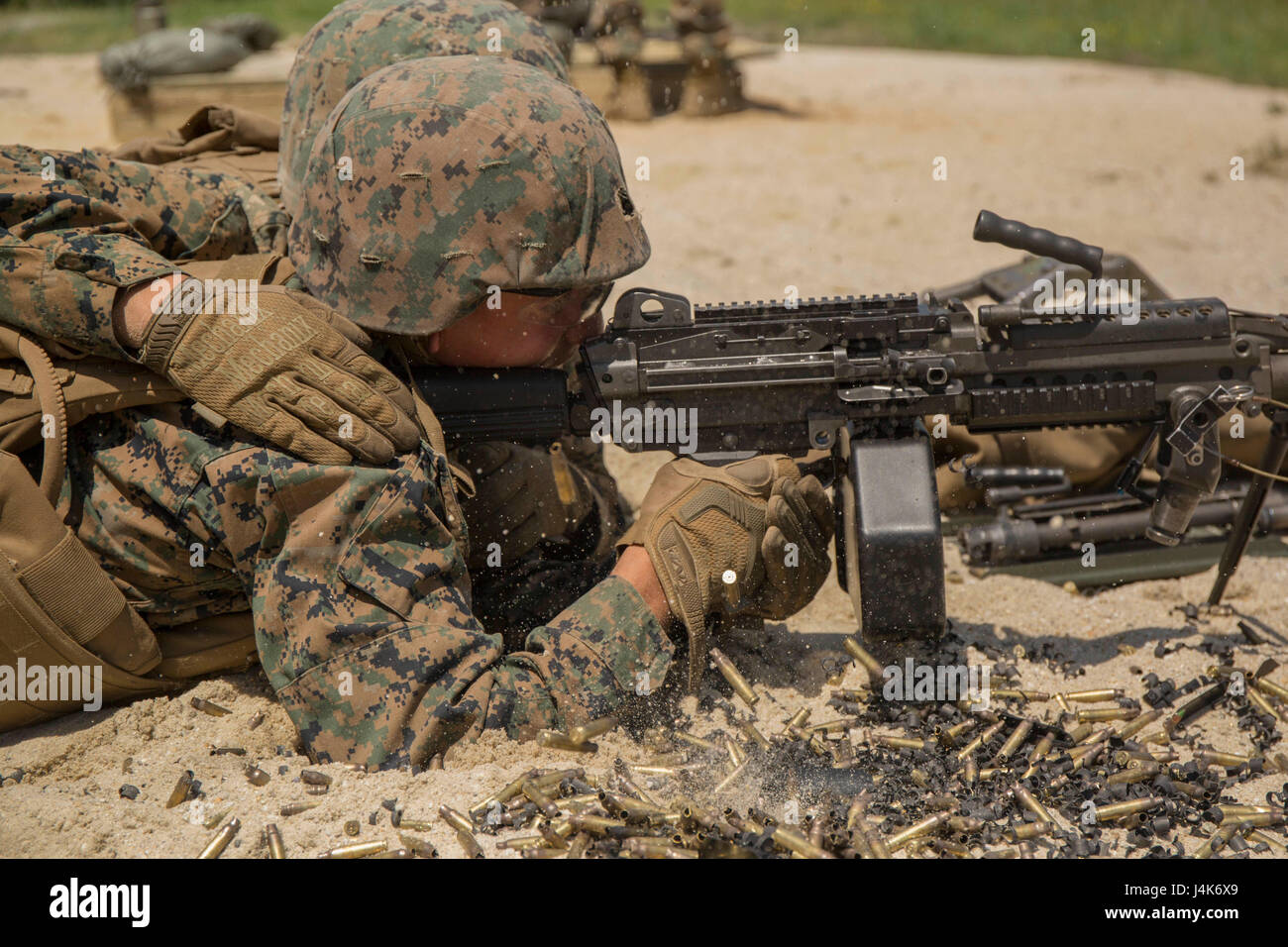 A Marine fires an M249 light machine gun during a machine gun course at ...