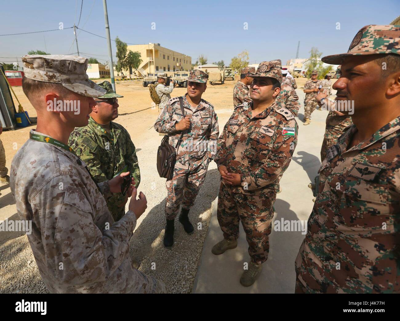 U.S. and Jordanian military personnel gather together for a meet and ...