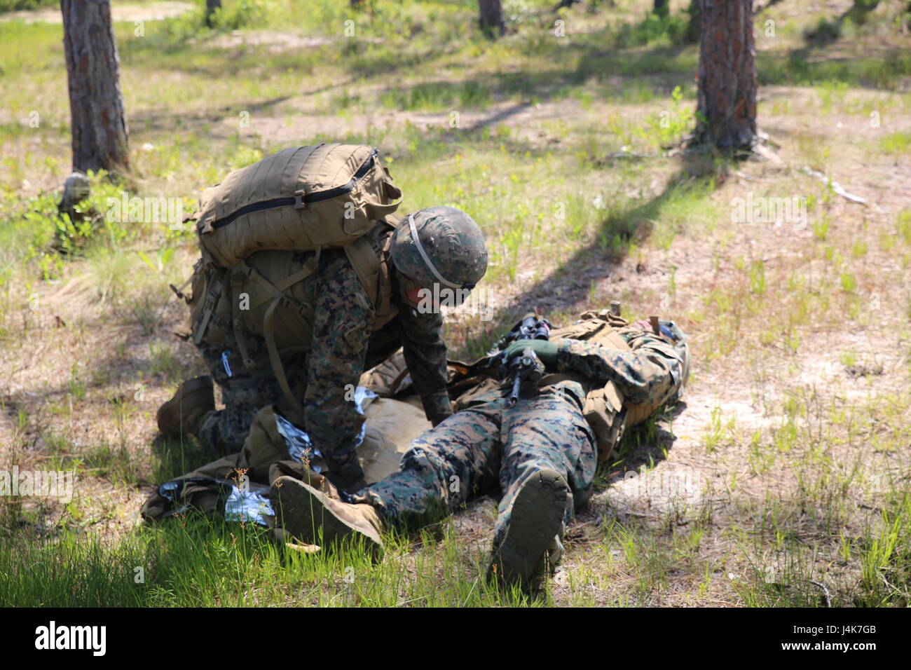 A Navy Hospital Corpsman provides first aid to a notionally injured ...