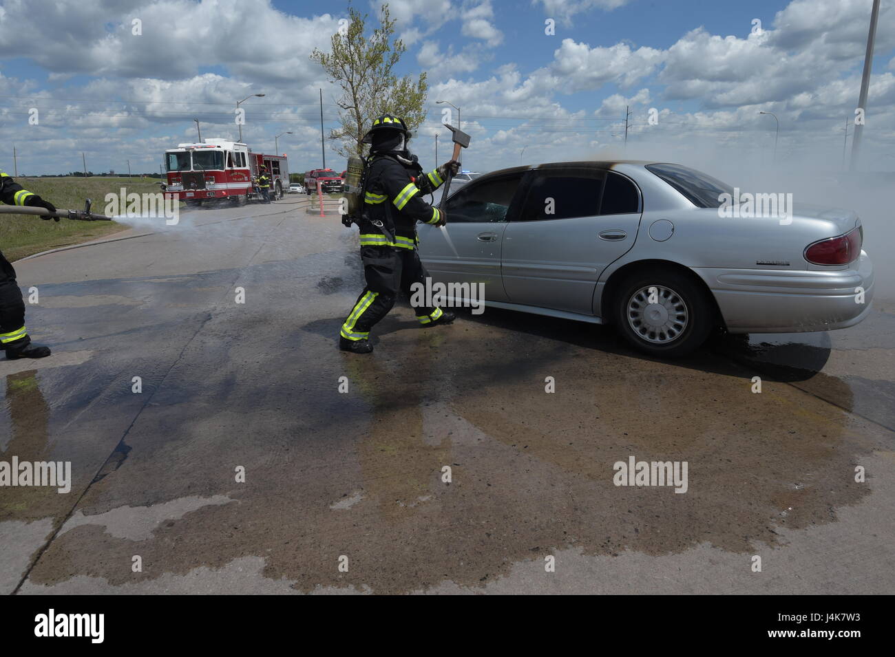 Aaron Simpson, Tinker Fire and Emergency Services firefighter, swings a ...