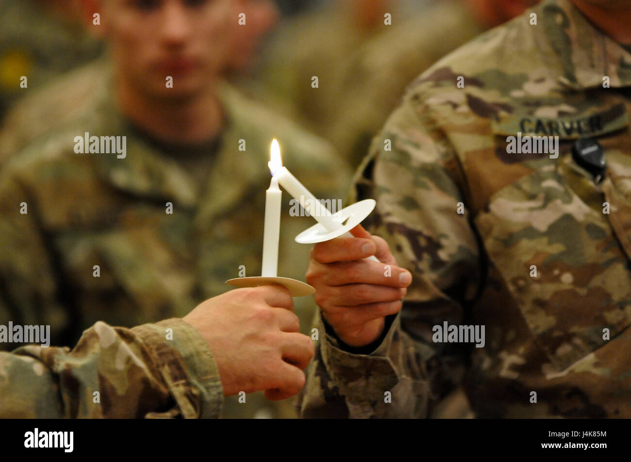Two U.S. Army Solders pass on the candle flame during a candle light ...