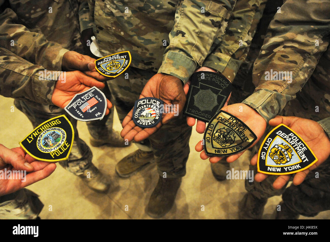U.S. Servicemembers, who are also law enforcements officers, show their ...