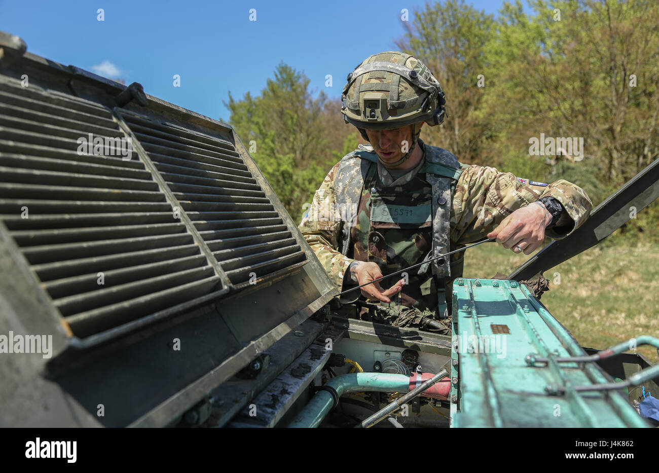 A British soldier performs pre-combat checks on an FV107 Scimitar ...