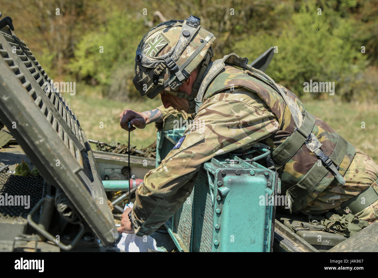 A British soldier performs pre-combat checks on an FV107 Scimitar ...