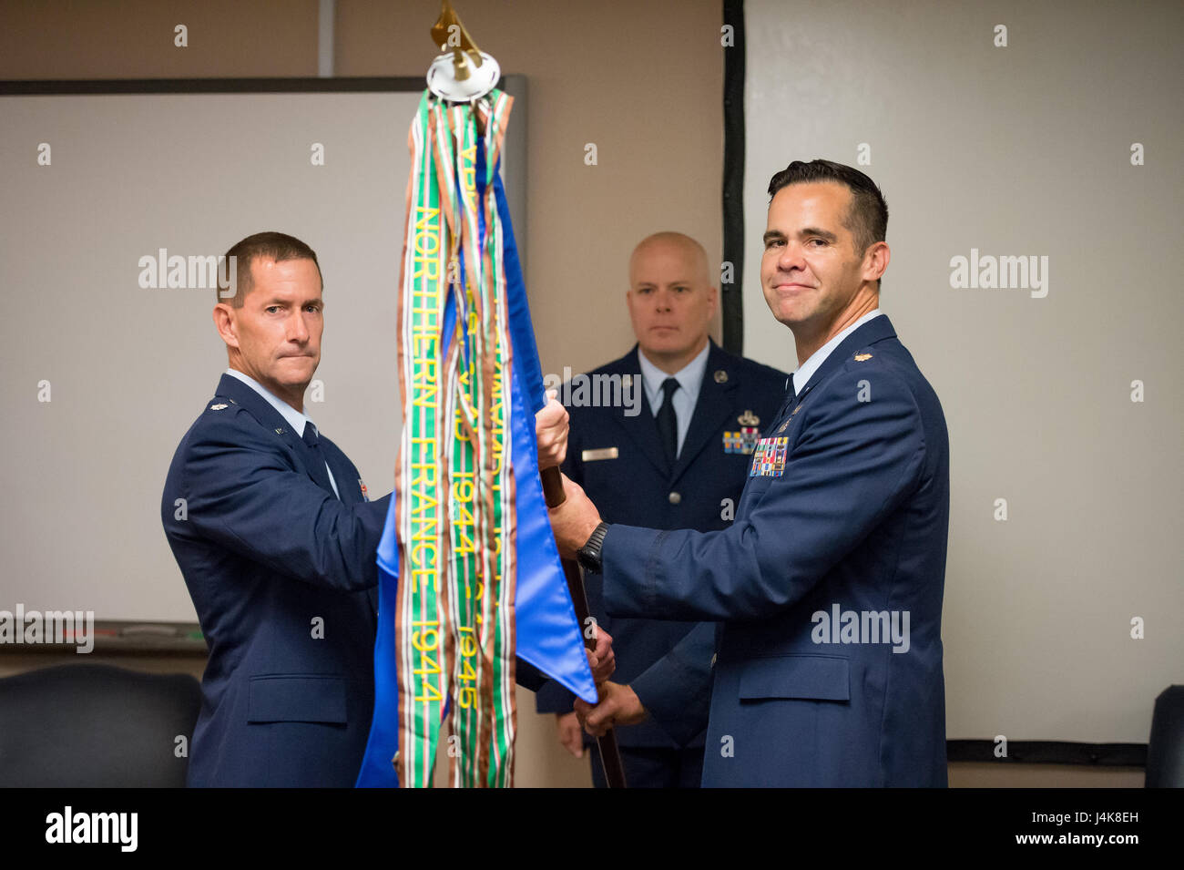 U.S. Air Force Lt. Col. John Robinson presents the guidon to Maj ...