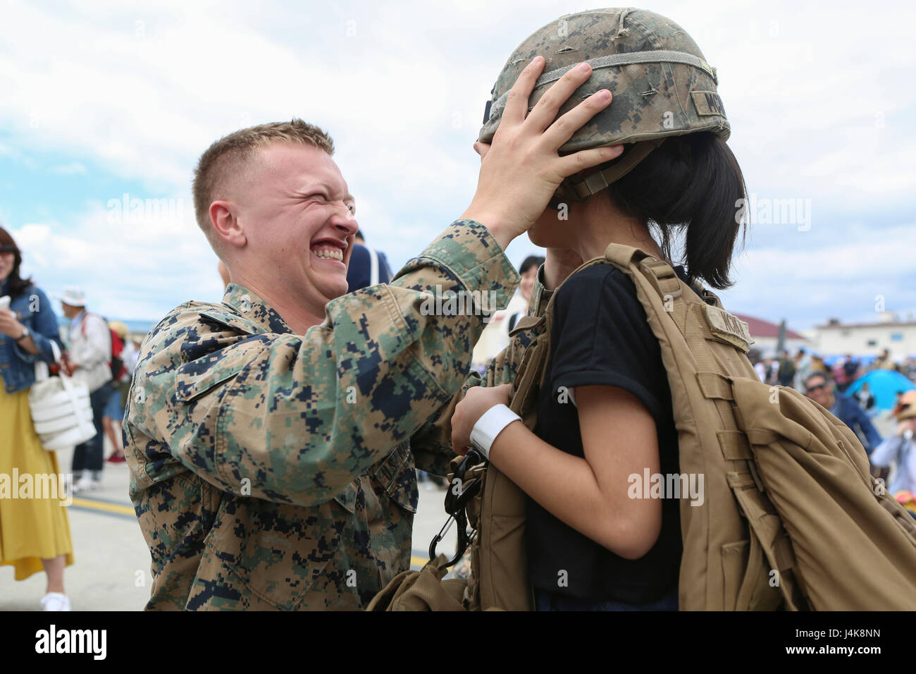 Lance Cpl. Riley Chappell, paints the face of a Japanese local during ...