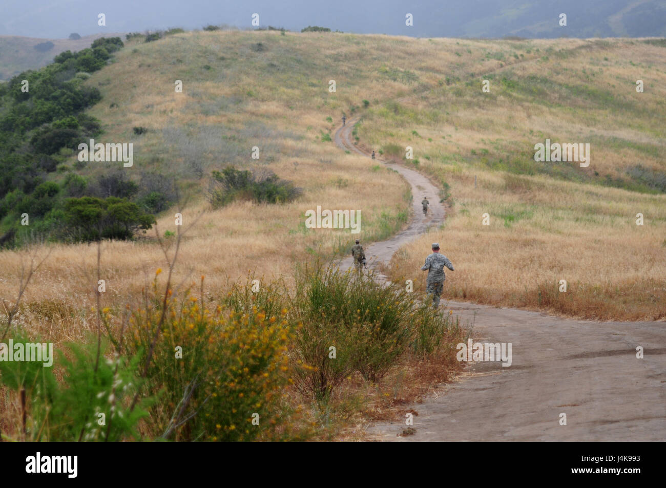U.S. Army Reserve Soldiers run down a dirt path during the 5k challenge ...
