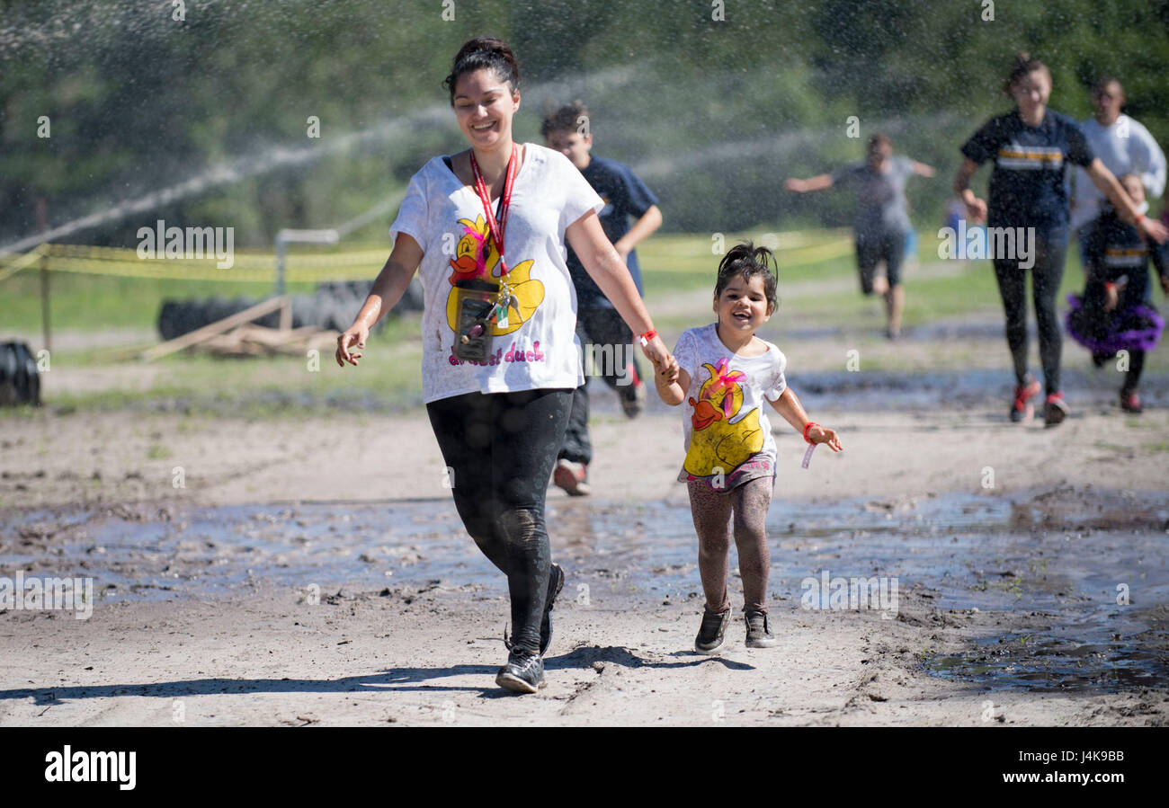 Participants run through water during the annual Moody Mud Run, May 6 ...