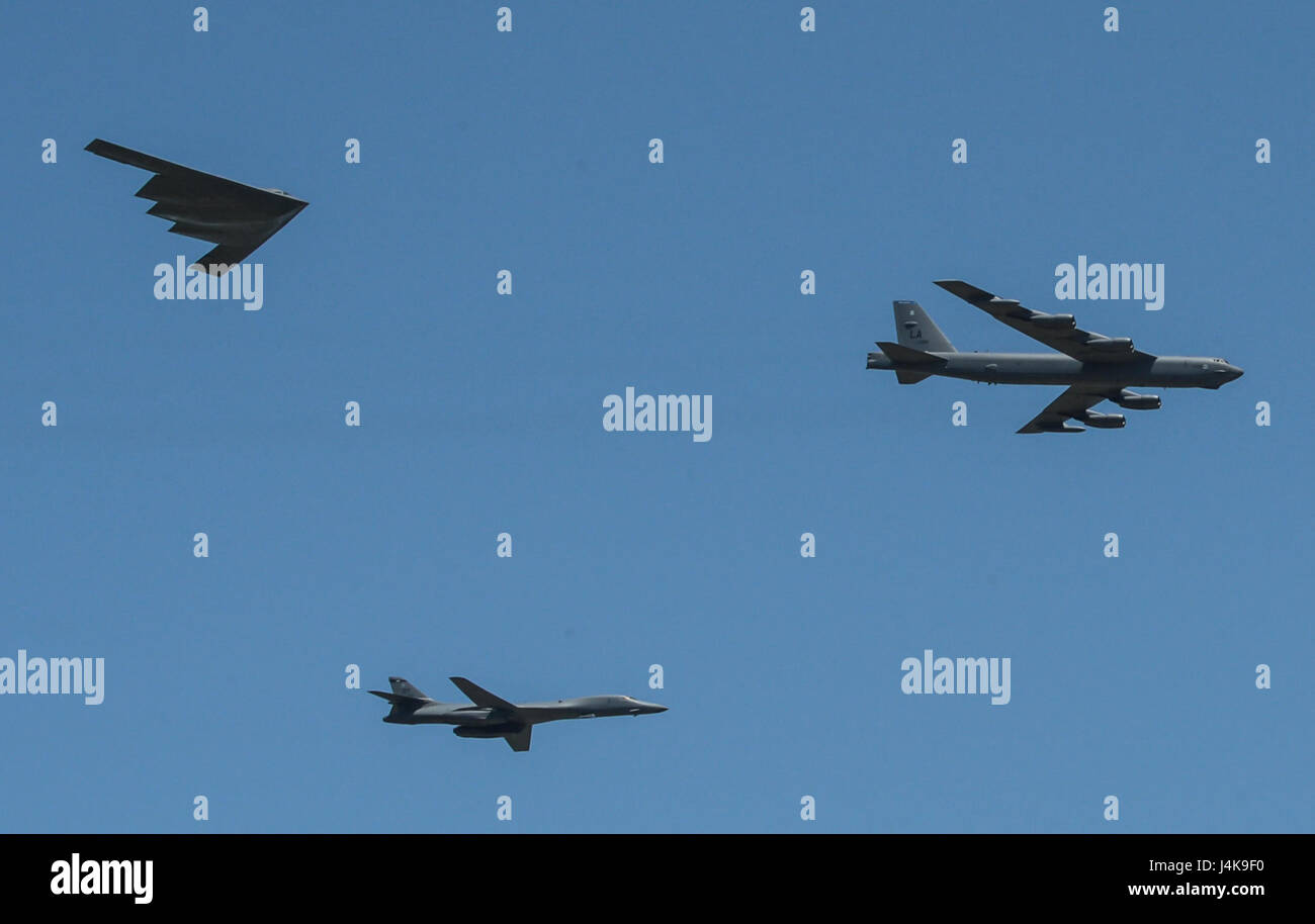 A B-1 Lancer, B-2 Spirit and B-52 Stratofortress perform a flyover ...