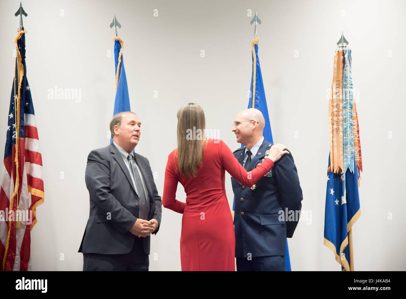 Col. Lisa Manion places a retirement pin on the lapel of her husband ...