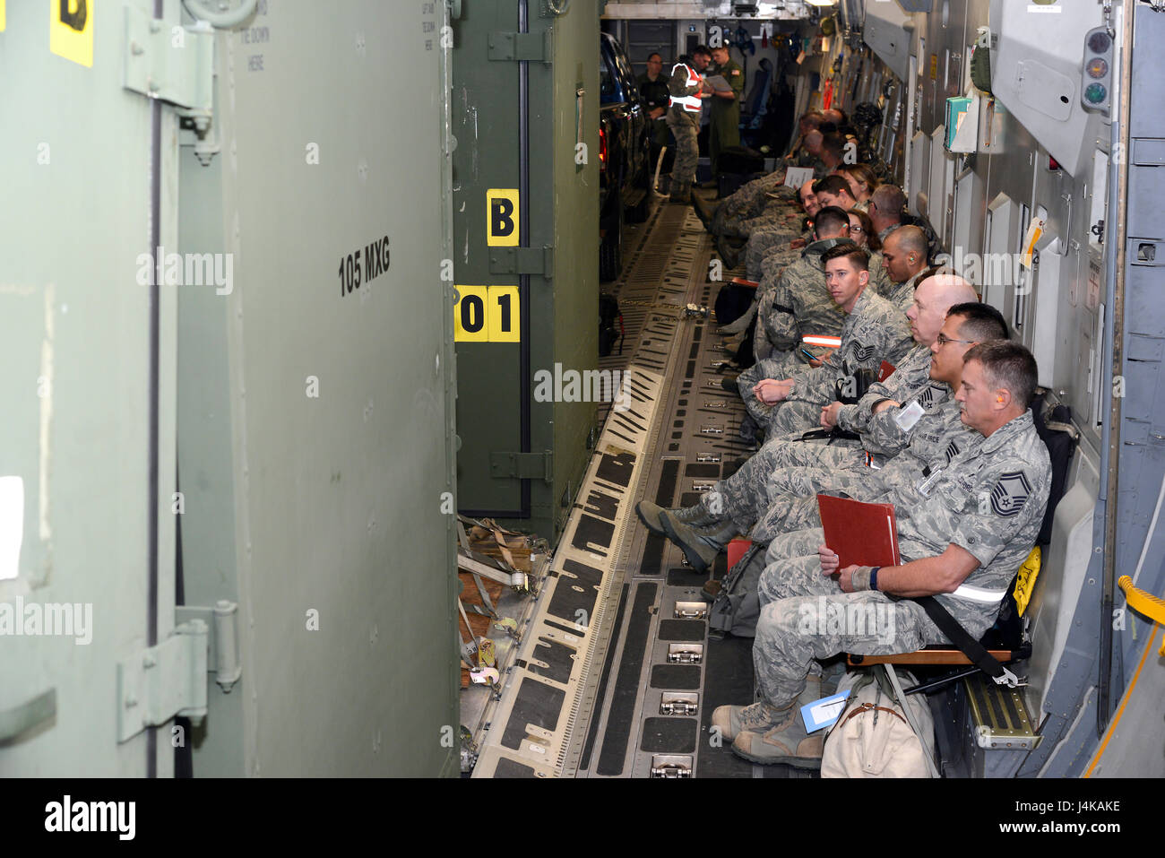 Airmen assigned to the 105th Airlift Wing await instruction on a C-17 ...