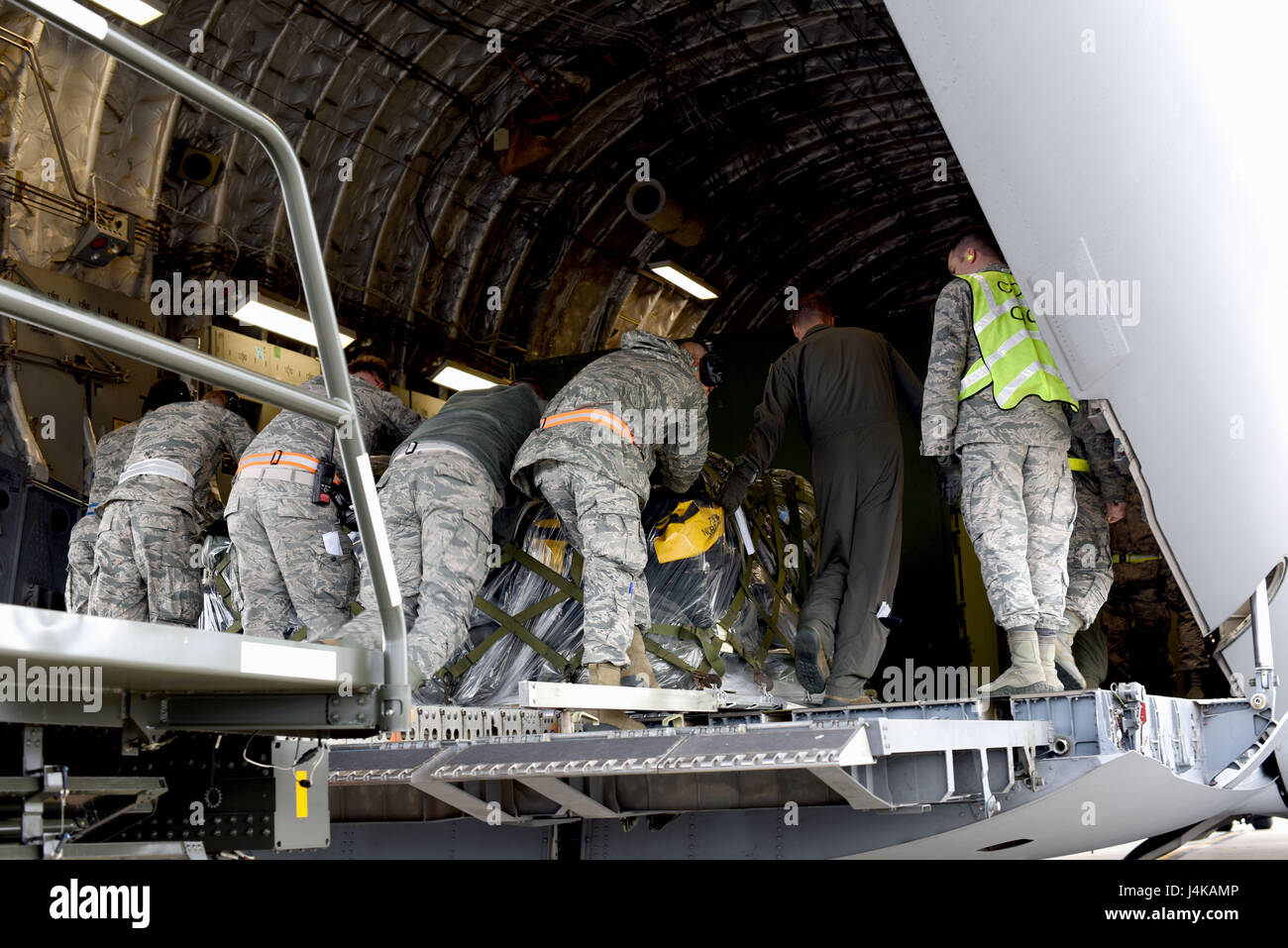 Airmen from multiple squadrons load cargo during an excerise at Stewart ...