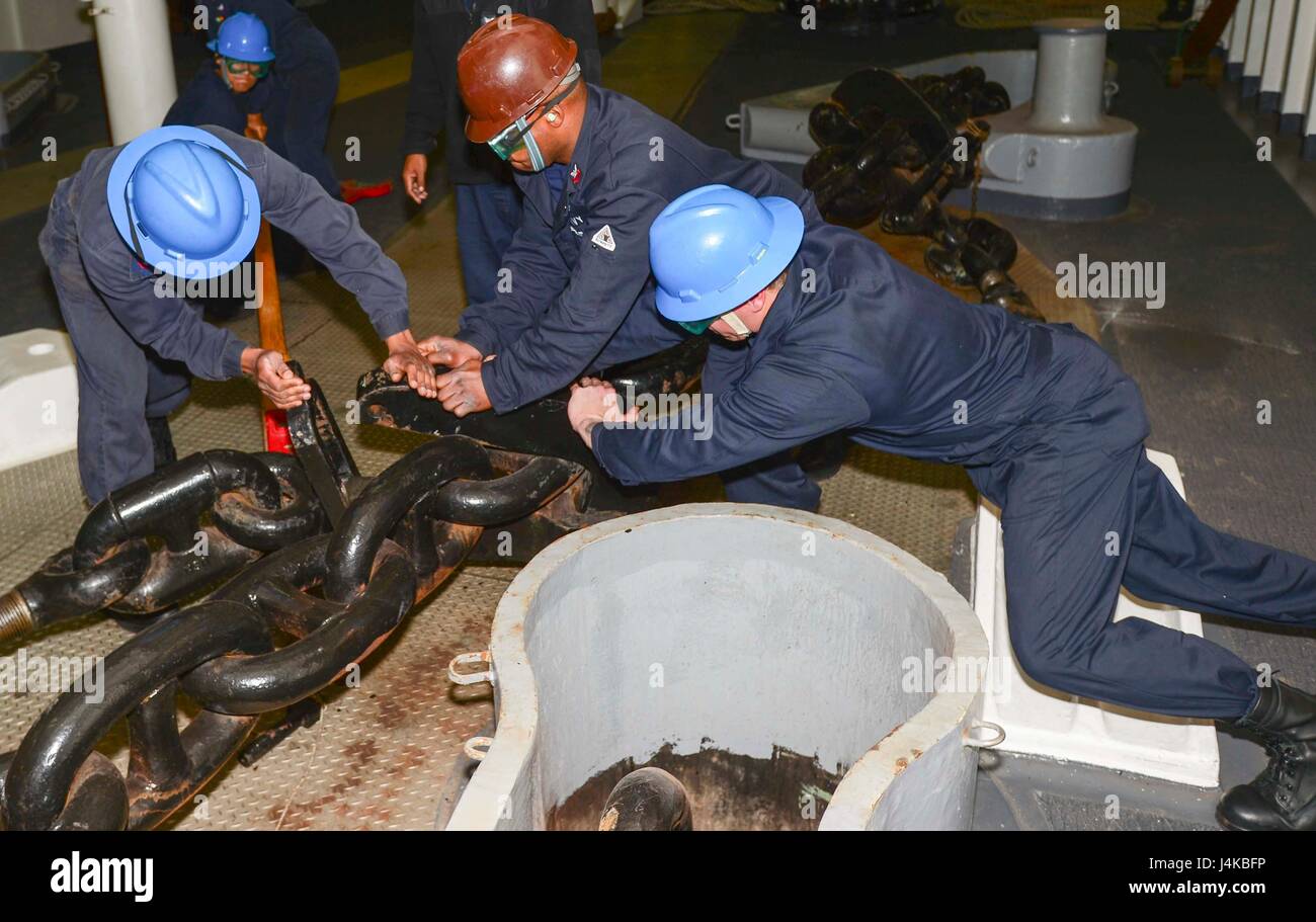 Deck department Sailors attach a pelican hook to an anchor chain during ...