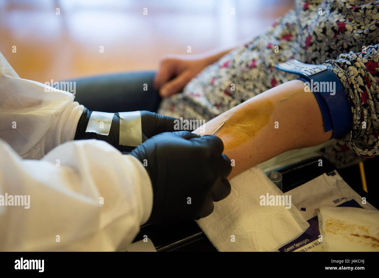 Jessica Behrens, a military spouse, donates blood during an Armed ...