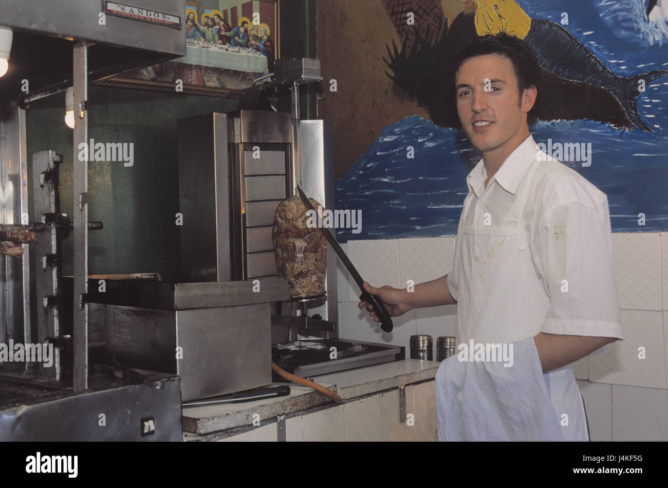 Greece, Santorin, Kamari Beach, Perigiali tavern, man, rotary spit ...