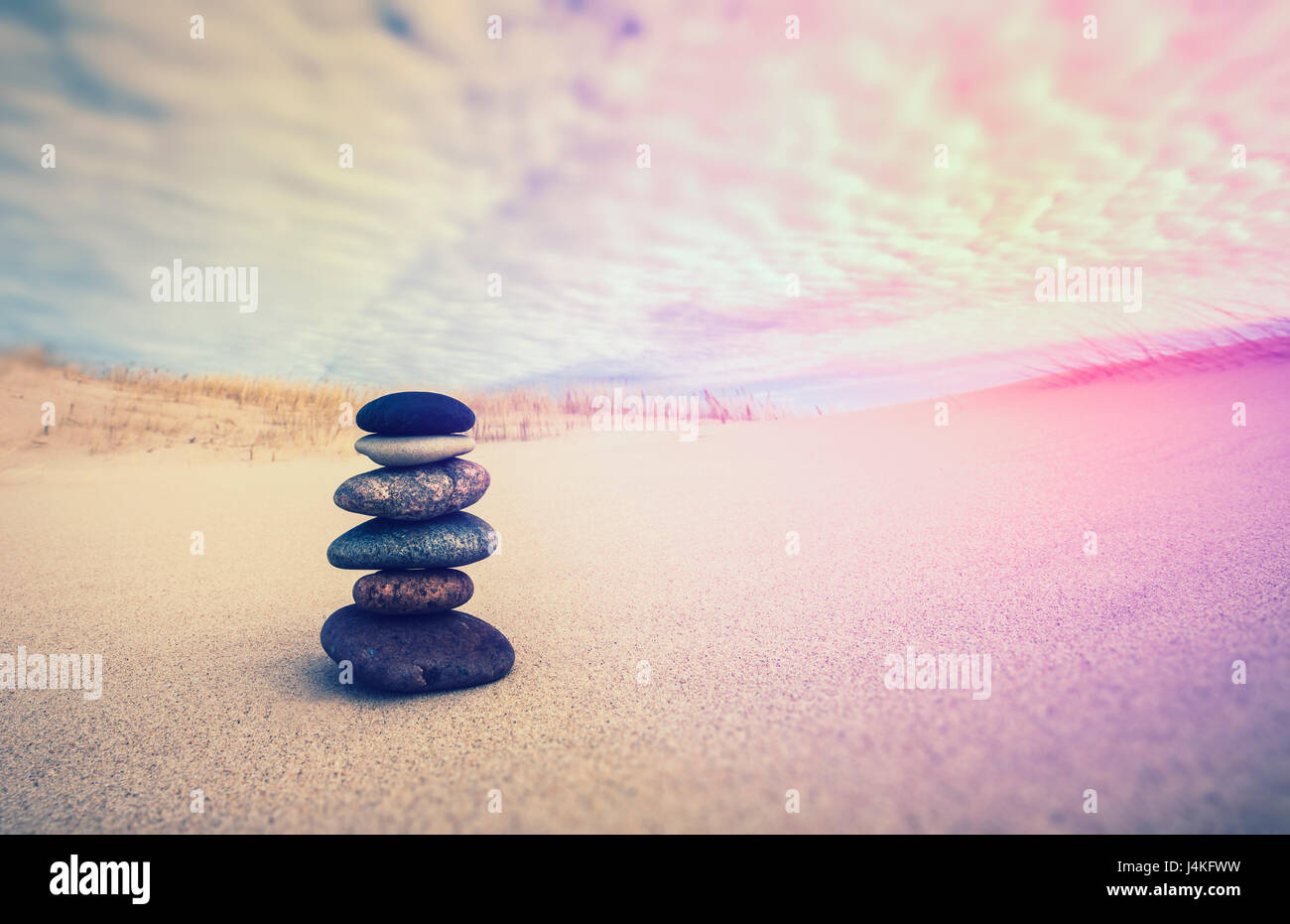 Stack of Balancing Pebbles on Sand Dune Stock Photo - Alamy