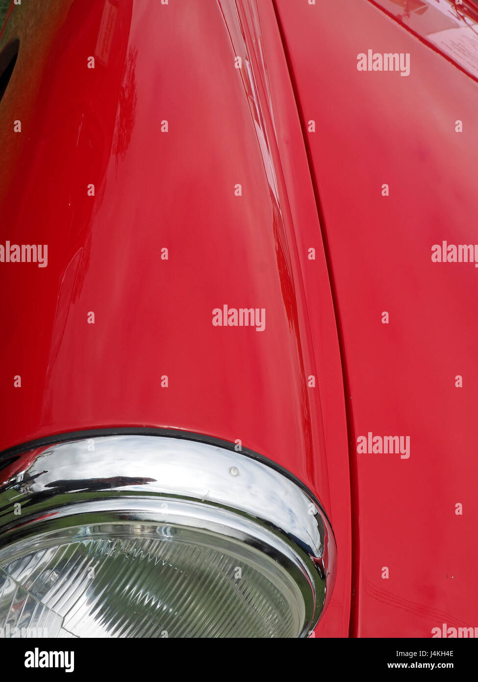 Detail of shiny red classic Austin Healey Sprite sports car with wing ...