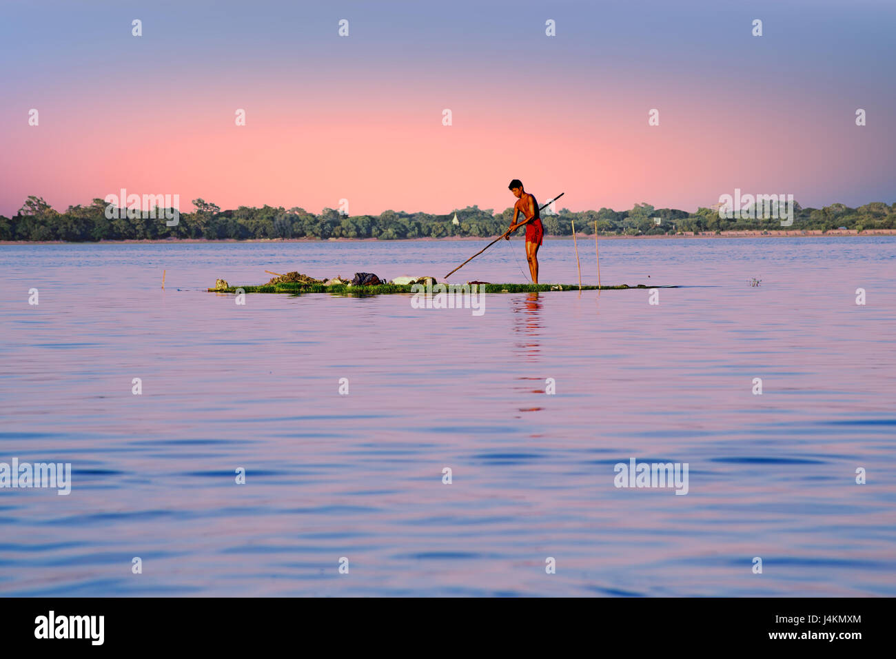 INLE LAKE, MYANMAR - NOVEMBER 15, 2015: Local worker collecting weed ...