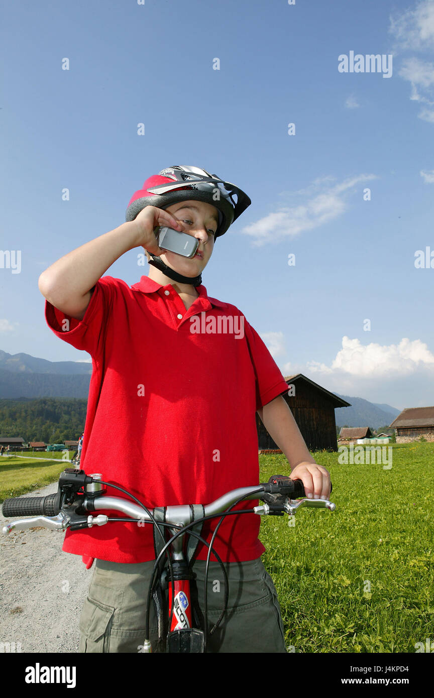 Country lane, boy, mountain bike, mobile phone, call up field scenery ...