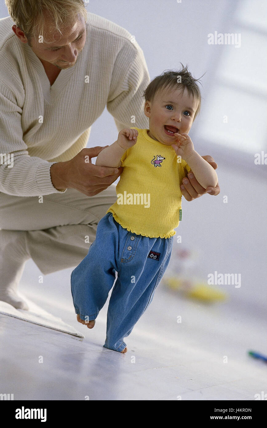 Infant, walking attempts, father, assistance inside, at home, child ...