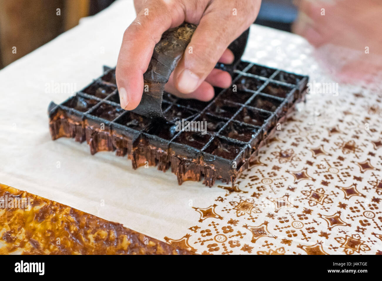 Printing on the fabric to make Batik 'Batik making is part of the ...