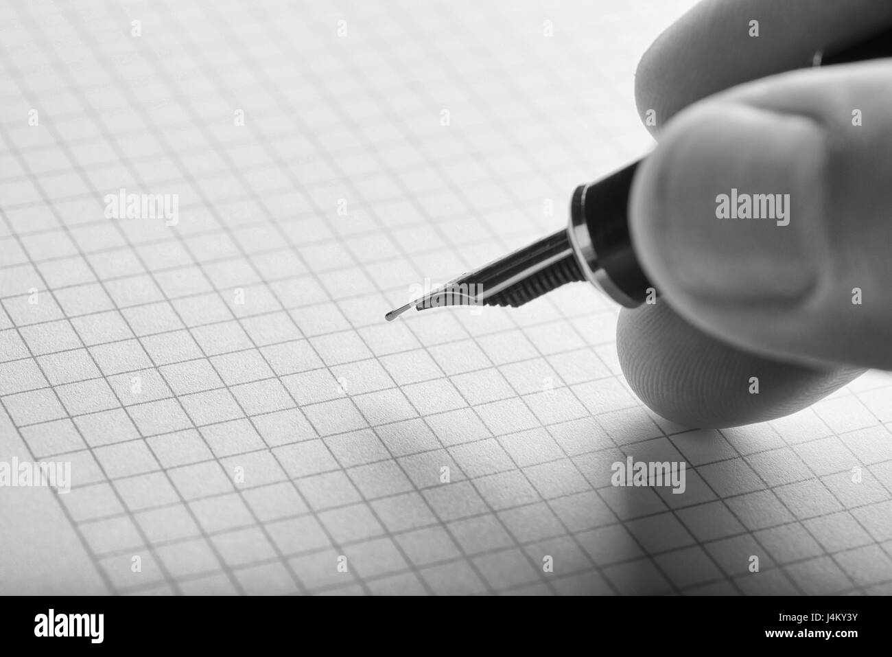 Hand holding a fountain pen to write on paper Stock Photo - Alamy