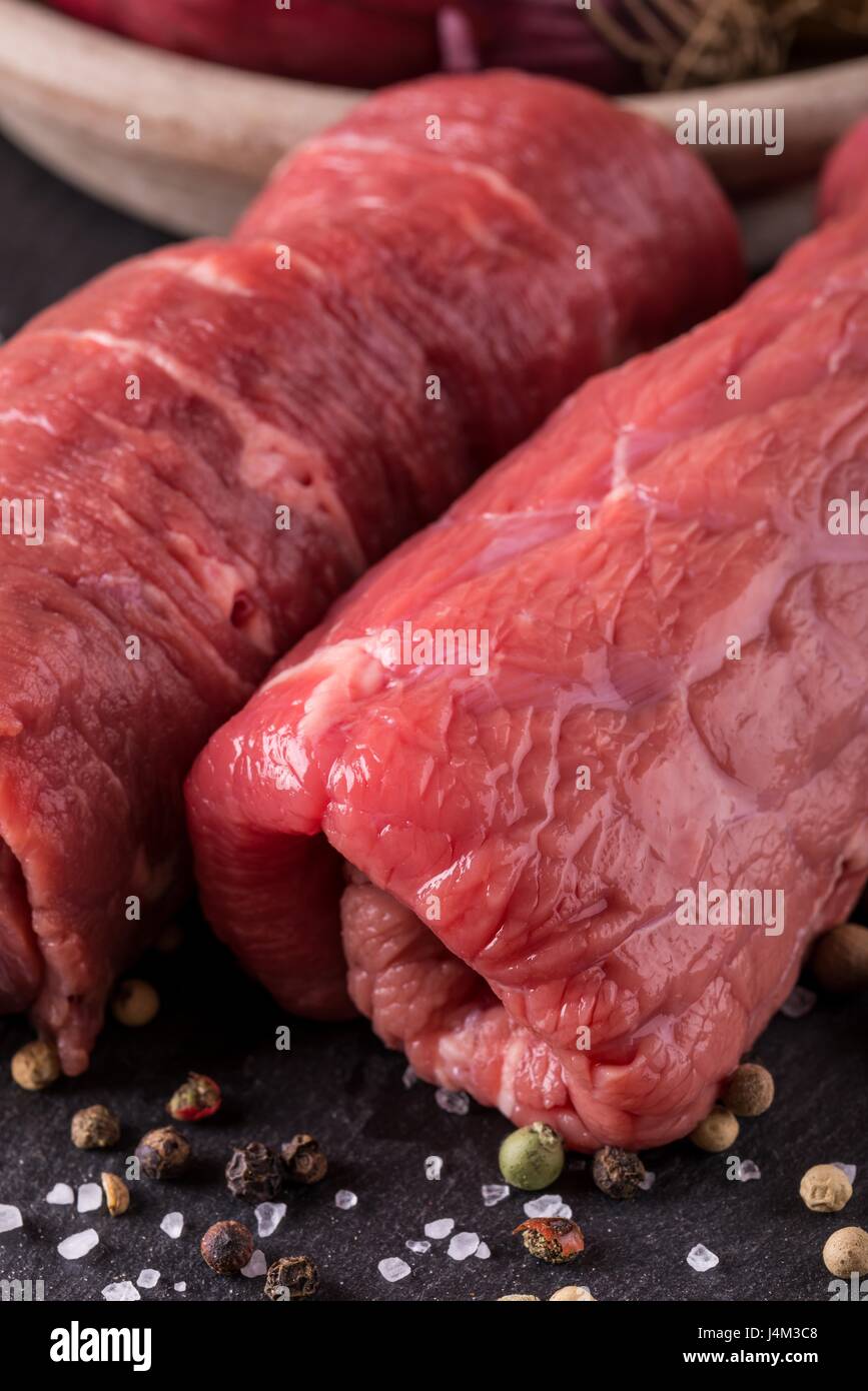 Vertical photo with detail of two rolled beef slices. Meat is prepared ...