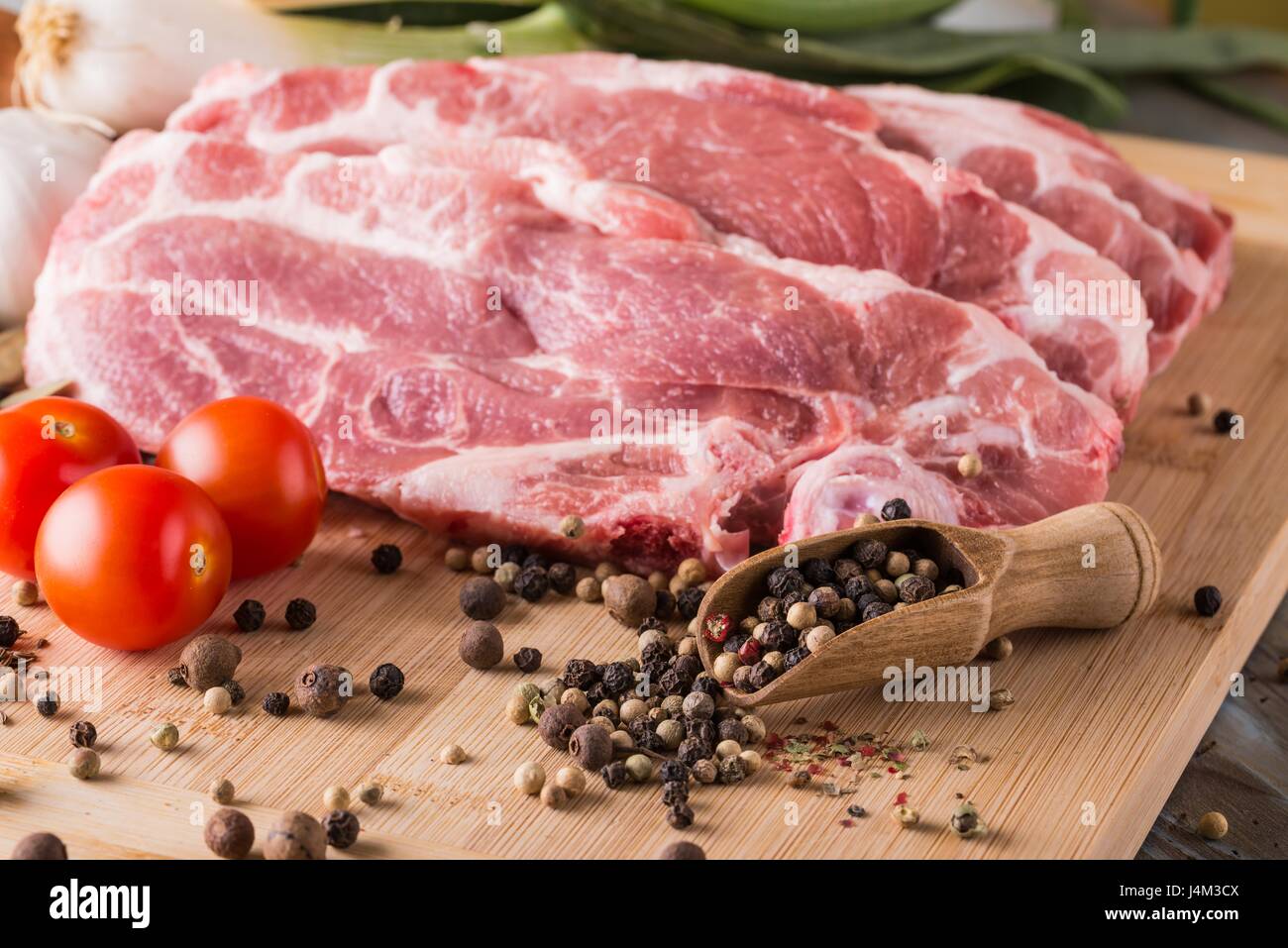 Horizontal photo with several slices of pork meat from neck. Meat has a ...