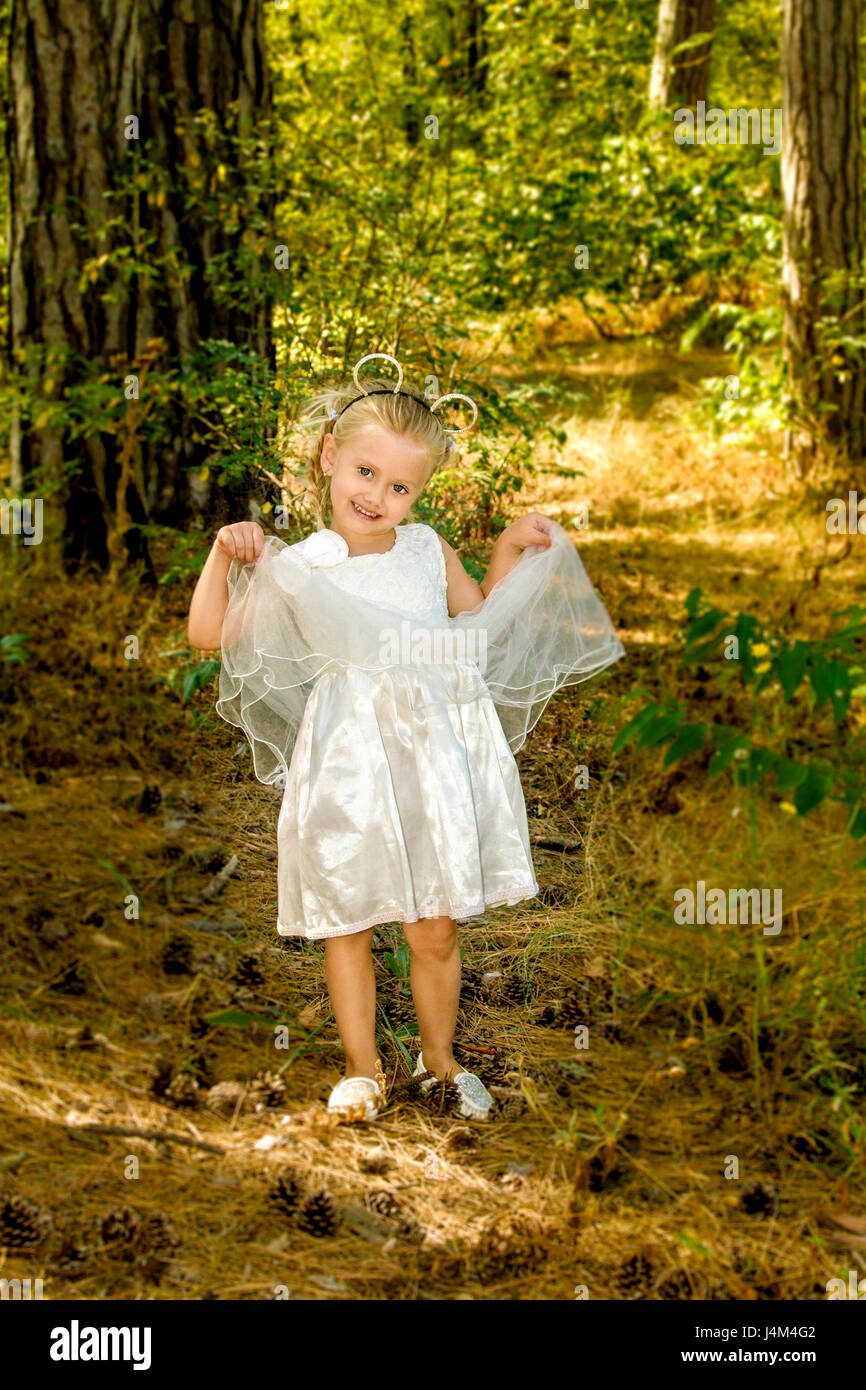 picture of little girl in a beautiful dress walks in the woods Stock ...