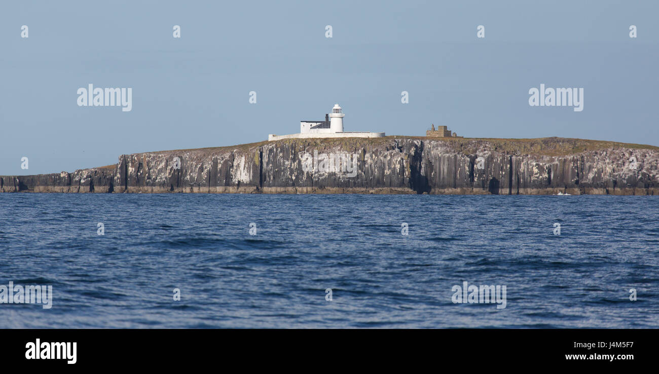 Inner Farne Lighthouse tops the cliff of the Farne Islands off the ...
