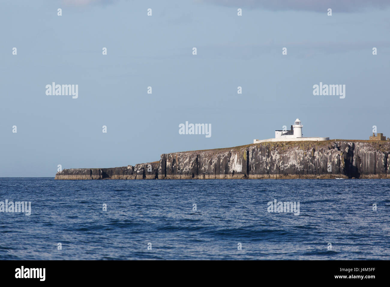 Inner Farne Lighthouse tops the cliff of the Farne Islands off the ...