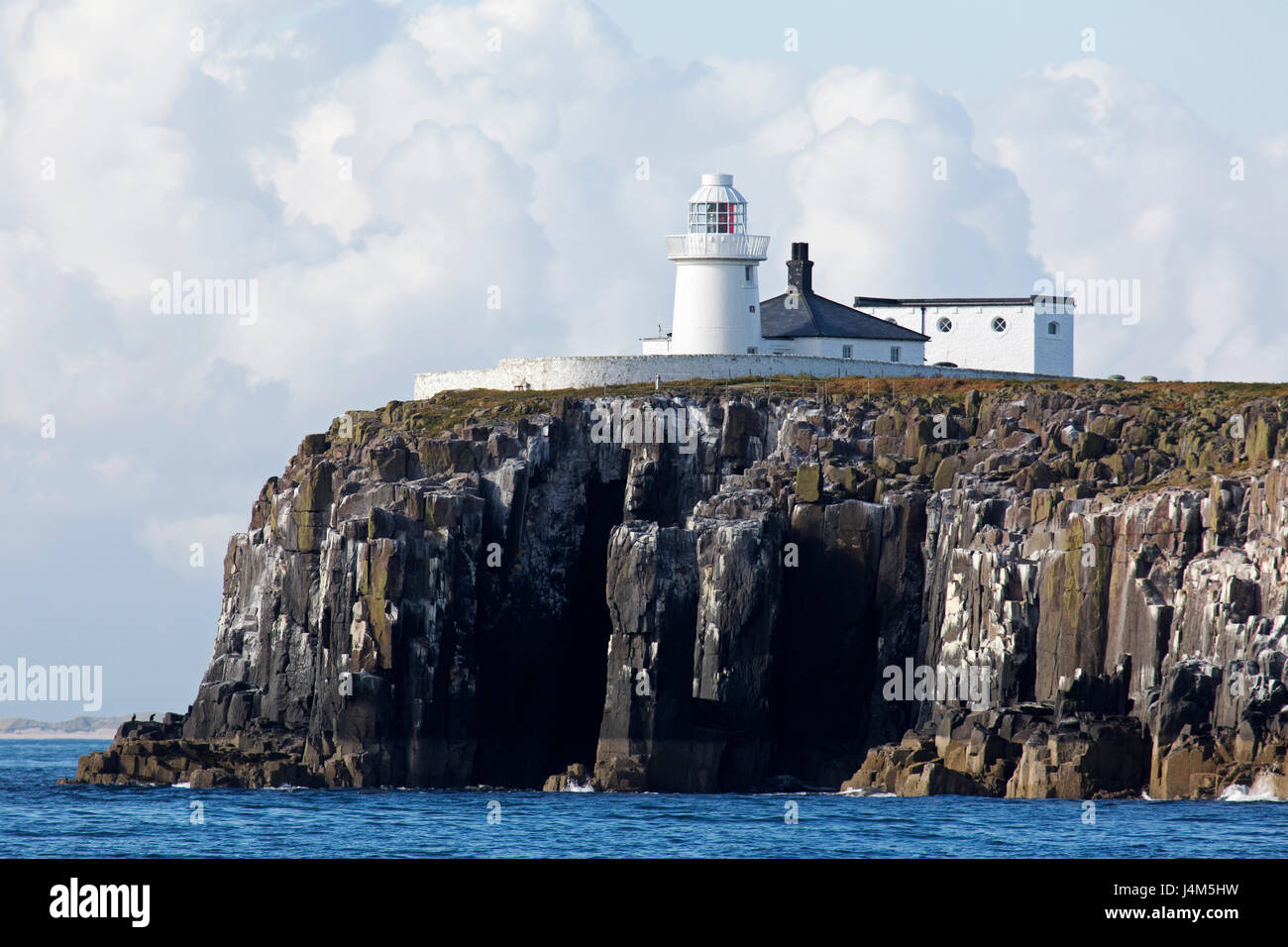 Inner Farne Lighthouse tops the cliff of the Farne Islands off the ...
