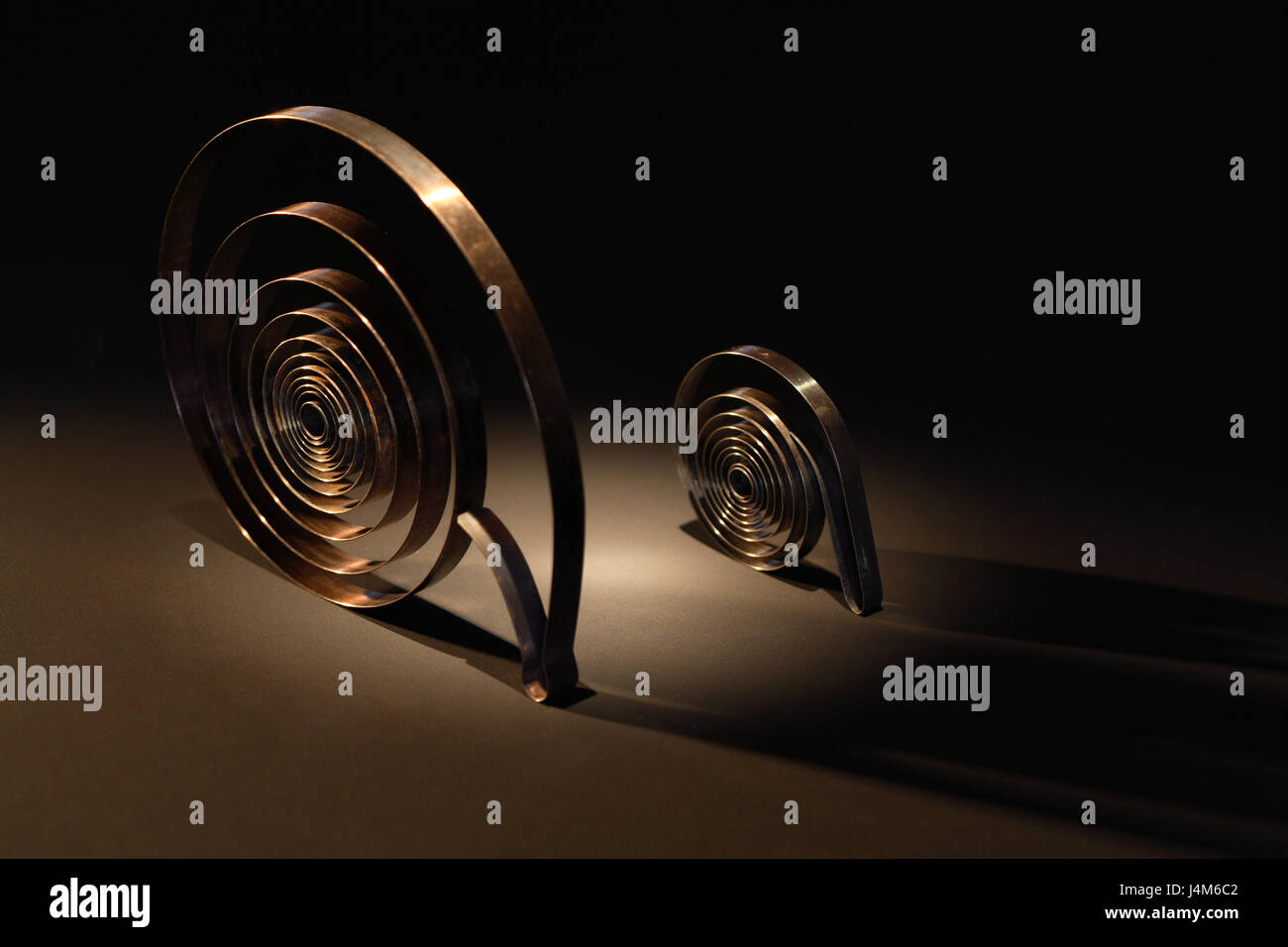 Pair of metal springs on dark background under beam of light Stock ...
