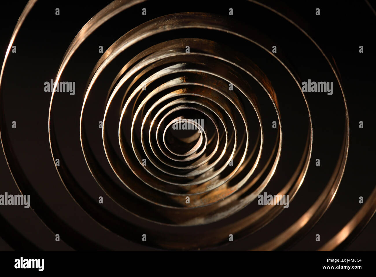 Rusty metal spring closeup on dark background Stock Photo - Alamy