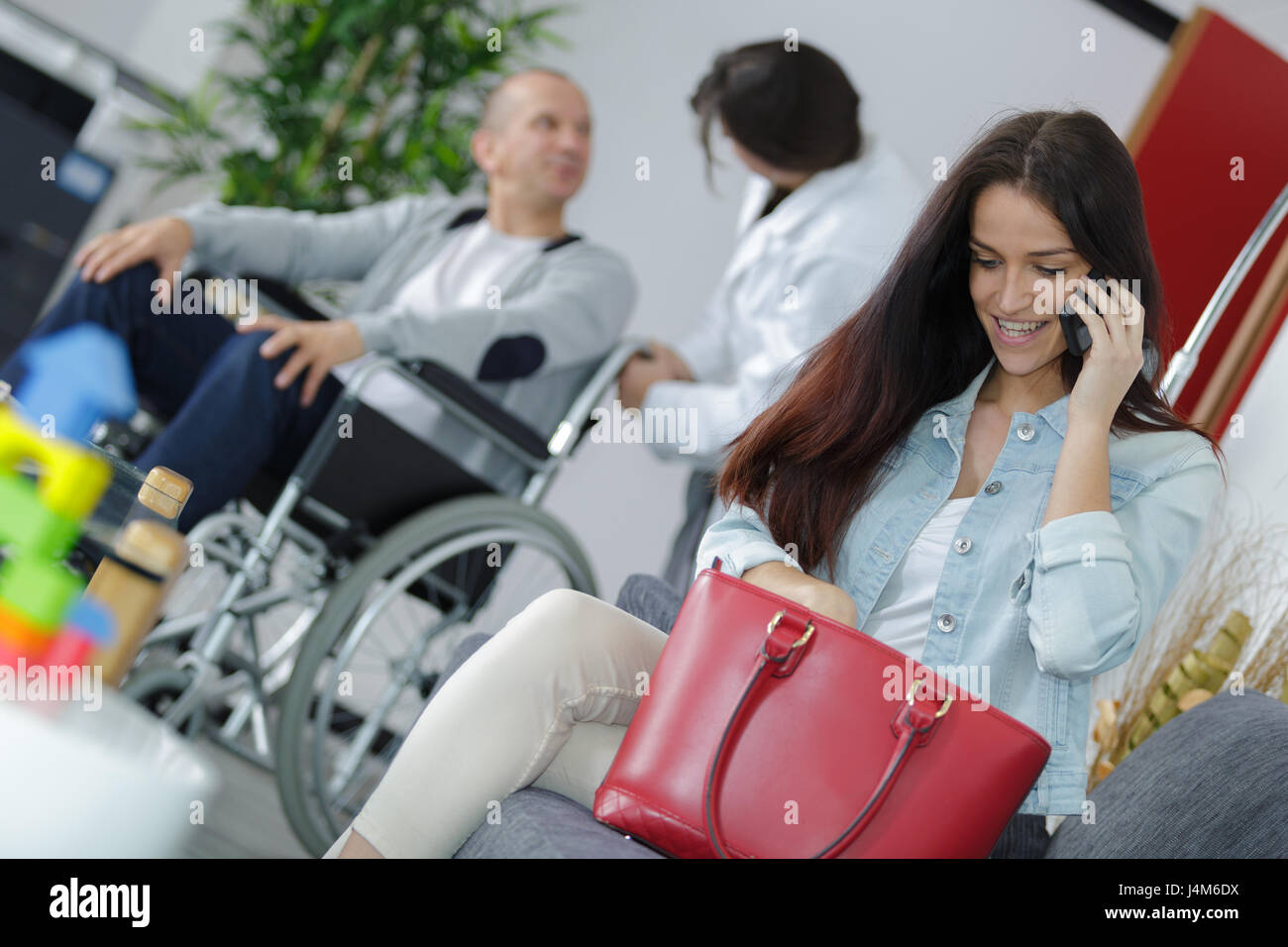 Lady making phone call from waiting room Stock Photo - Alamy
