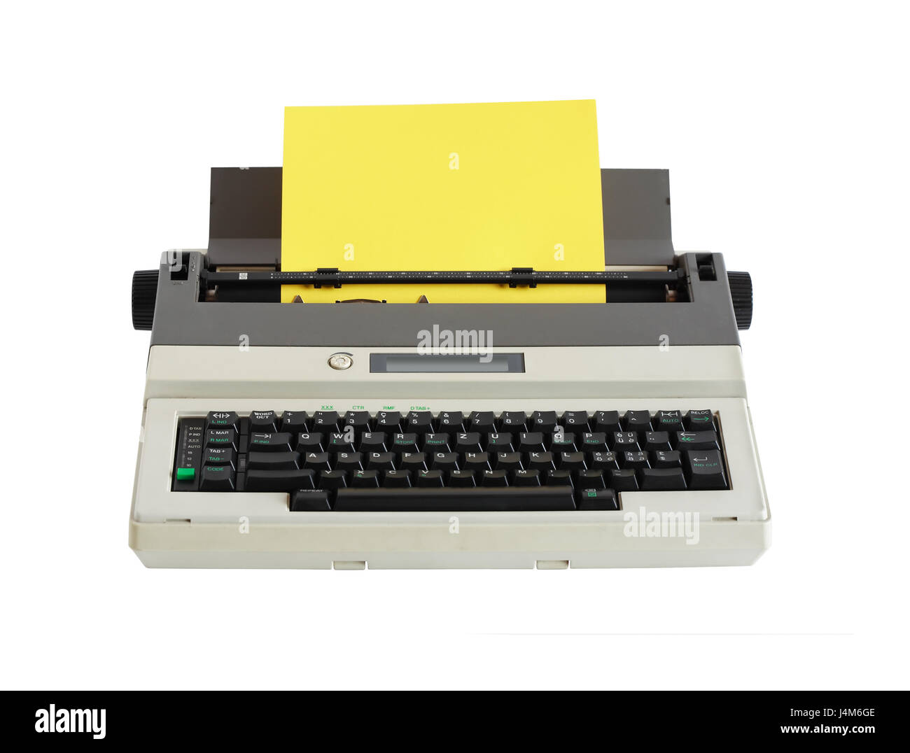 Electrical typewriter with blank yellow paper sheet on white background ...