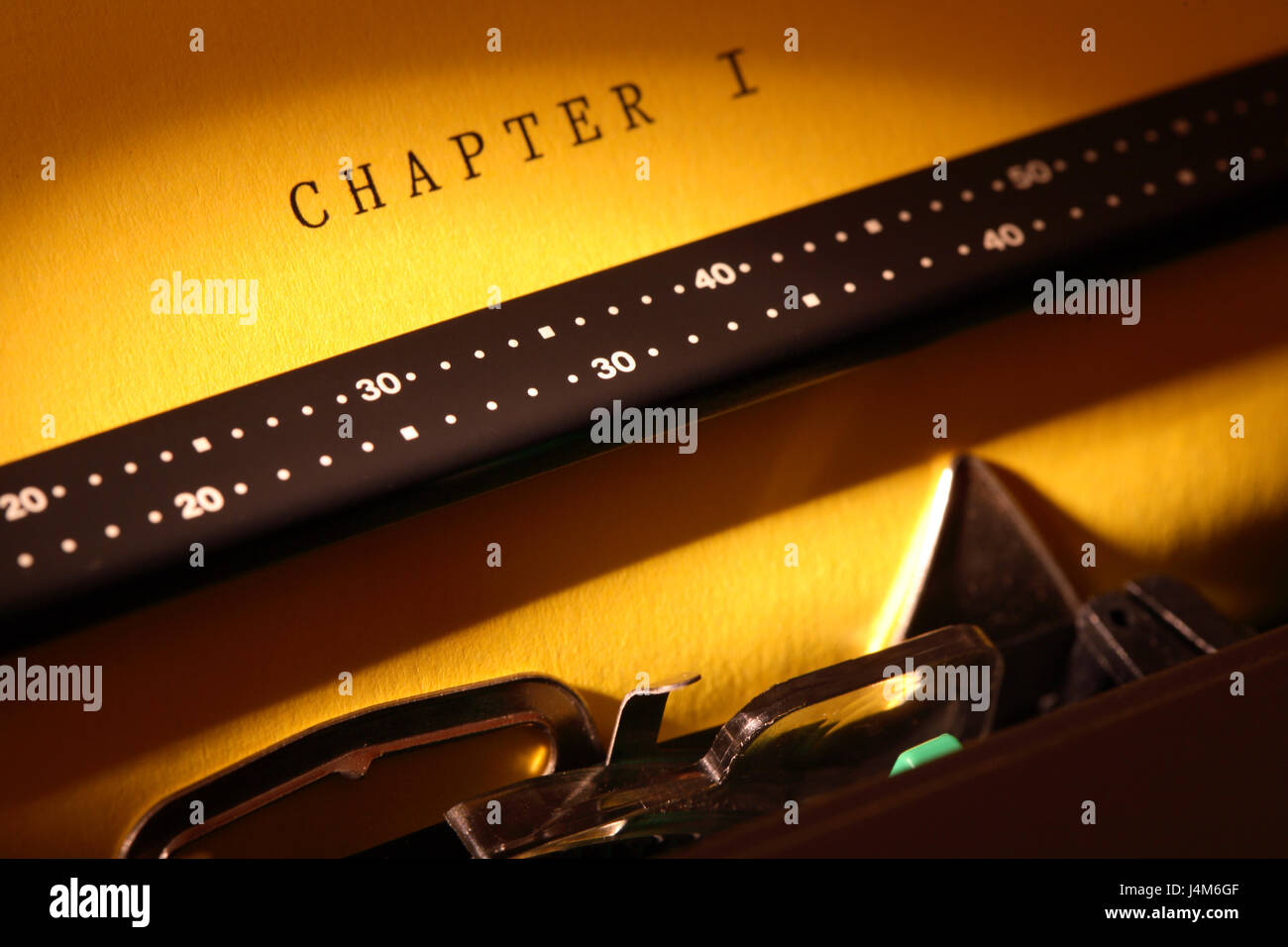Closeup of electrical typewriter with yellow paper sheet. Inscription ...