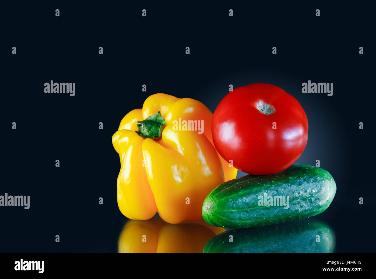 Color vegetables on dark background with reflection Stock Photo - Alamy