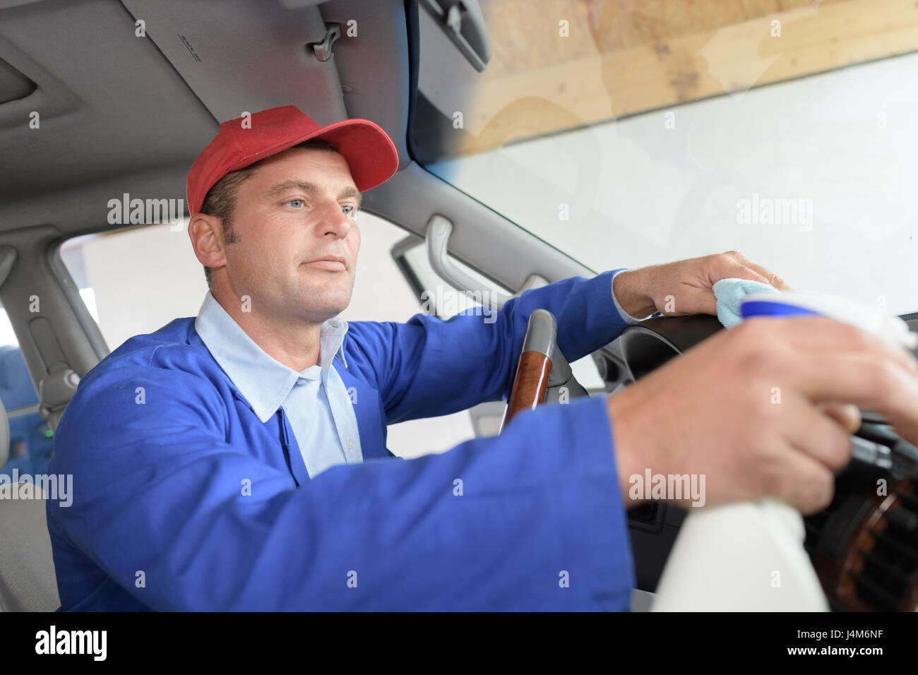 Man cleaning vehicle cab Stock Photo - Alamy