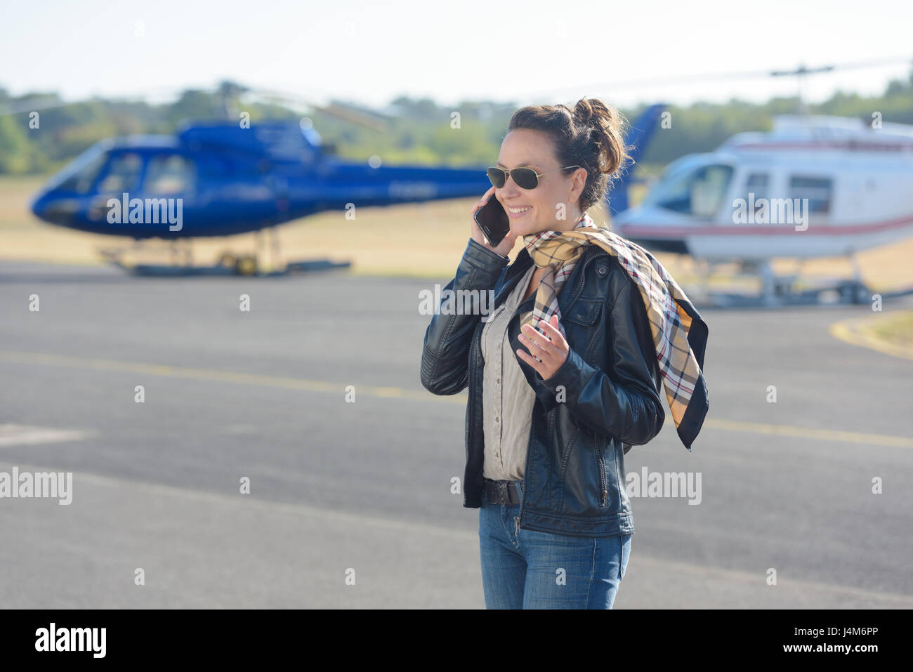 confident pilot with phone smiling in the private helicopter Stock ...