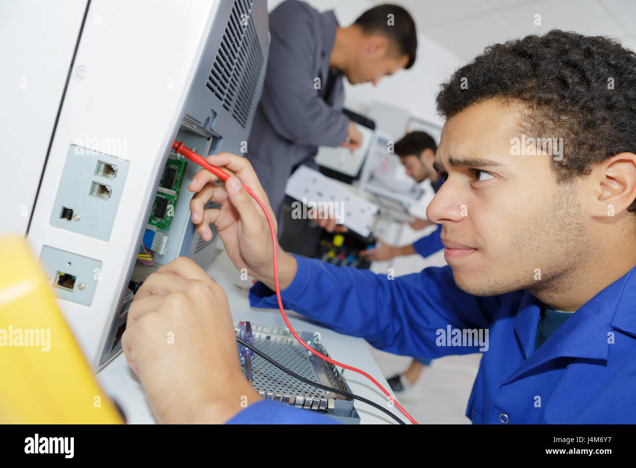 Frowning student using multimeter Stock Photo - Alamy