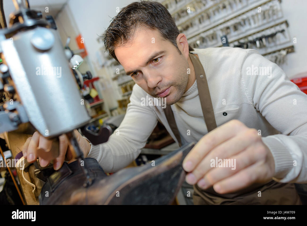 Cobbler using sewing machine Stock Photo - Alamy