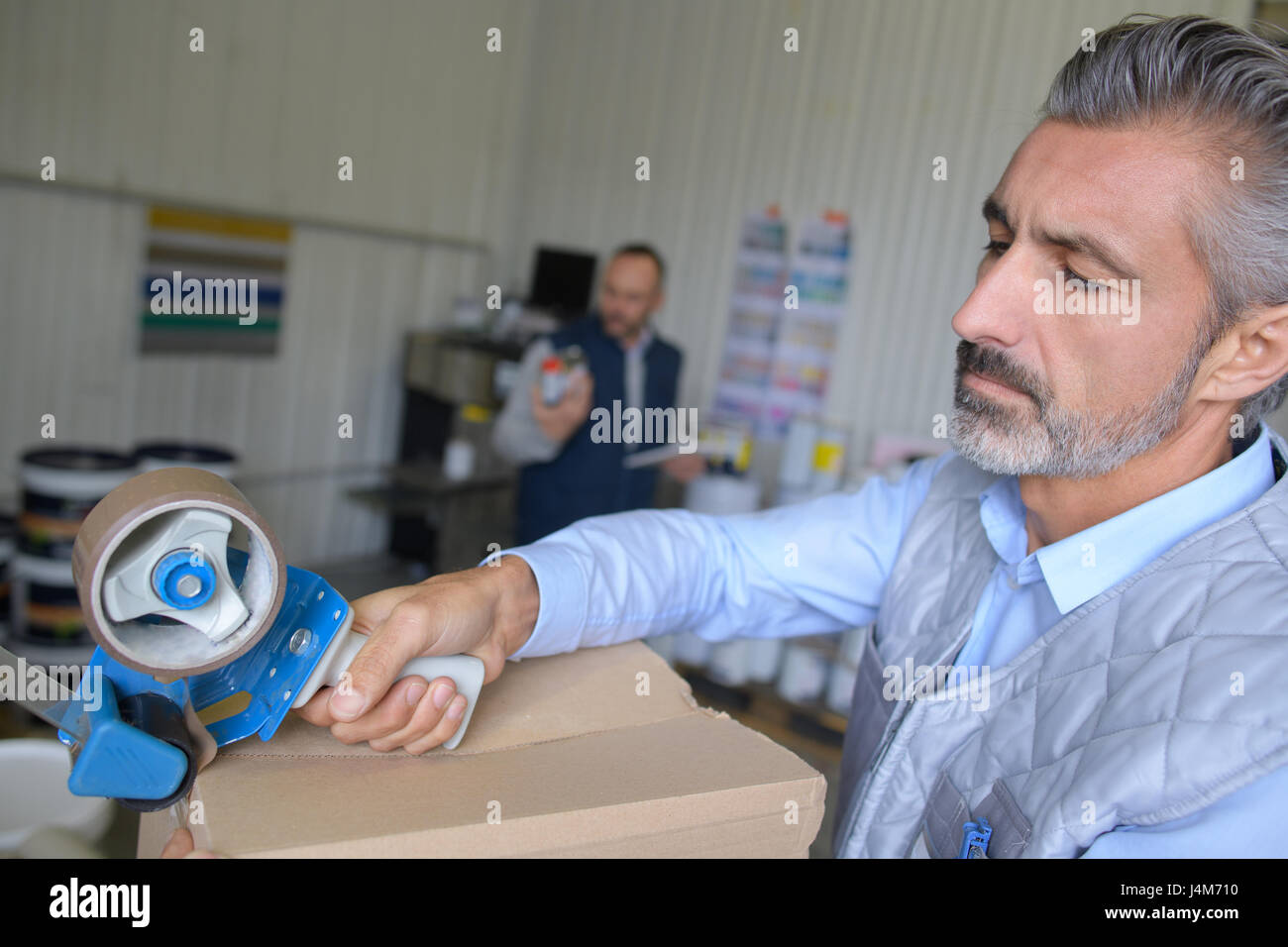 Man using dispenser adhesive tape hi-res stock photography and images ...