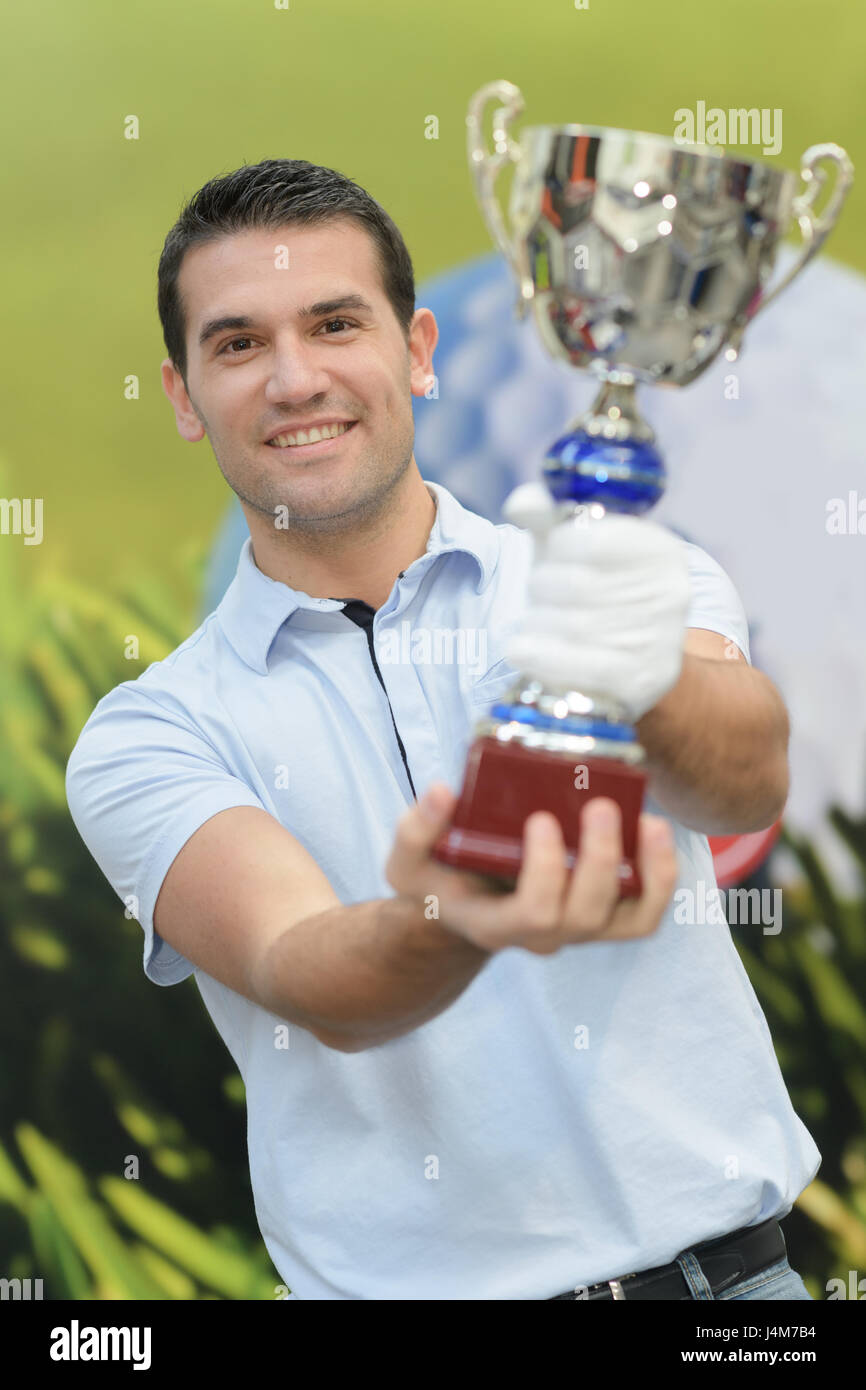 young man holding a trophy Stock Photo - Alamy