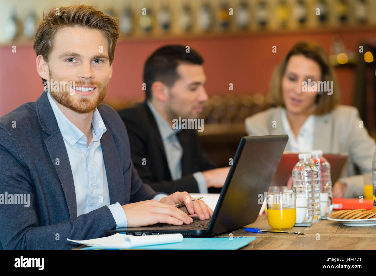 portrait of man in cafn© using laptop Stock Photo - Alamy