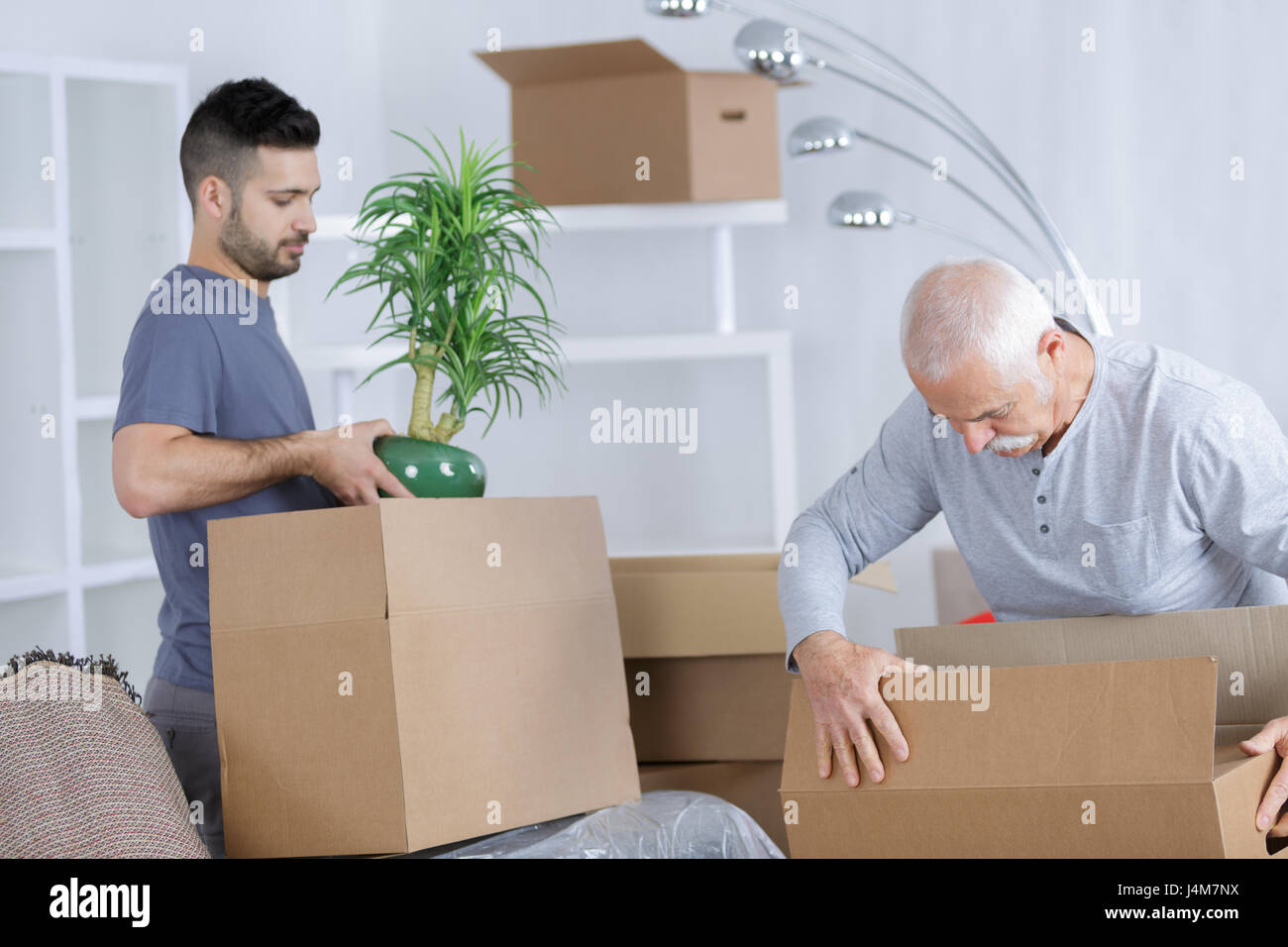 Men unpacking boxes Stock Photo - Alamy