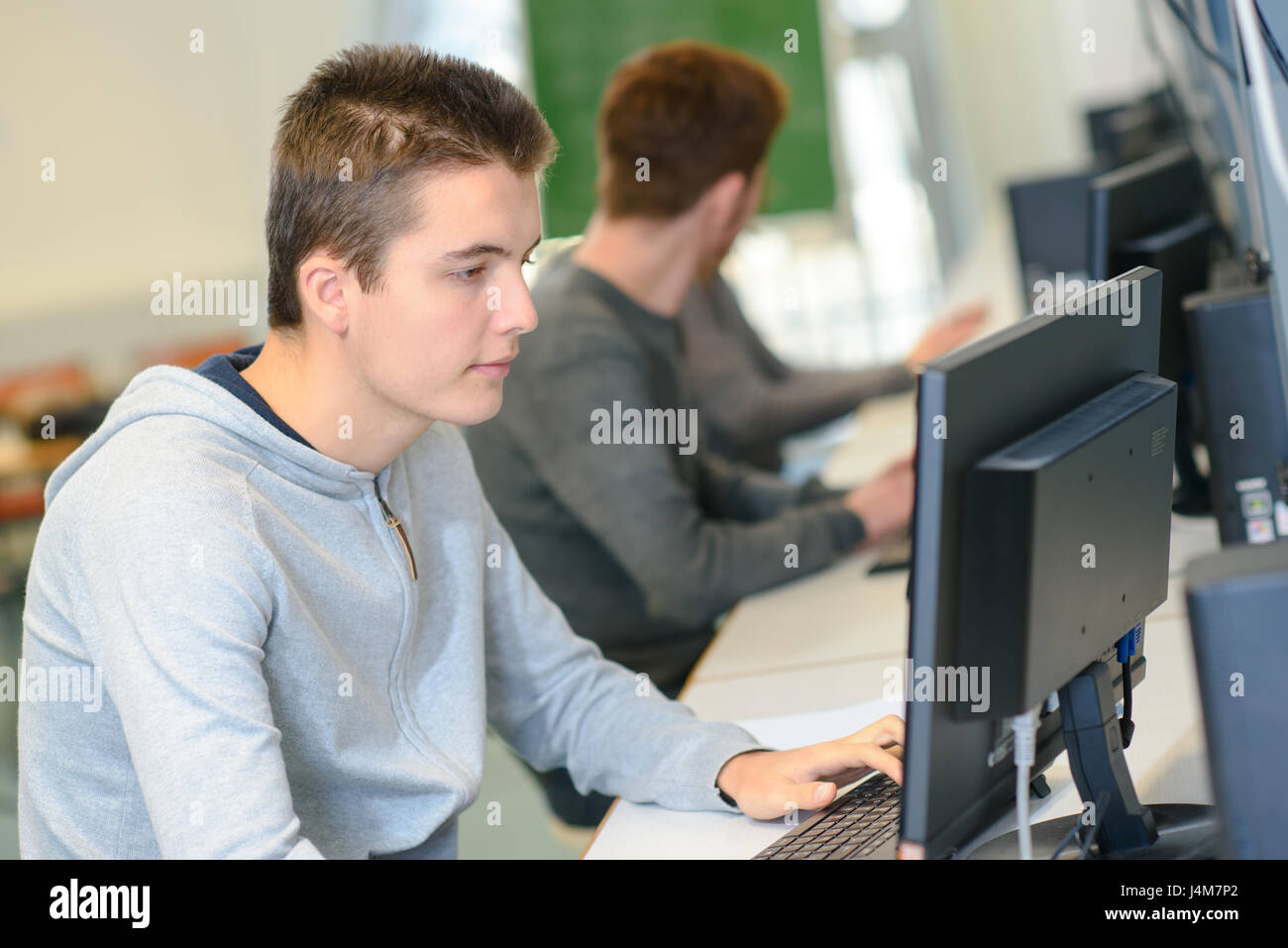 male teenage student working at computer at school Stock Photo - Alamy