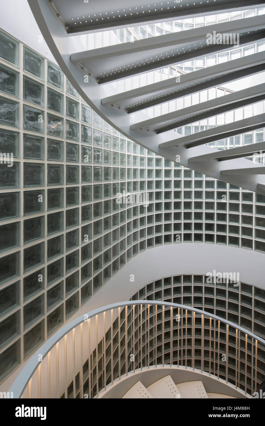 Detail of helical staircase and glass brick facade. Housing Building ...