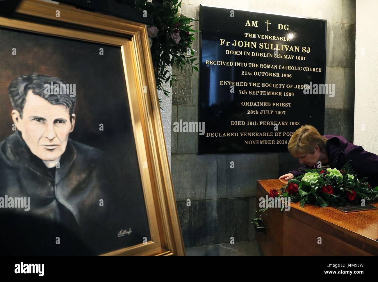 People pay their respects at the remains of Fr John Sullivan following ...